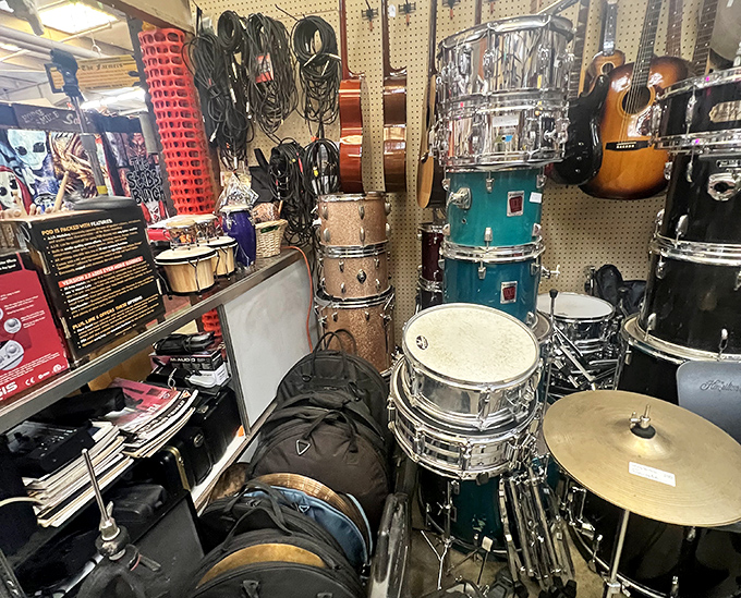 A musician's paradise tucked between vendor stalls, where vintage drums and guitars wait for their next gig or display wall.