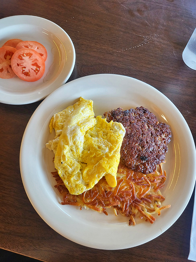The breakfast plate that hits all the right notes: fluffy eggs, crispy hash browns, and a protein that means business.