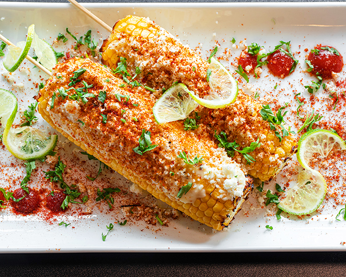 Elote that's dressed better than most people at a wedding. Lime, cilantro, and spice create a corn-based masterpiece.