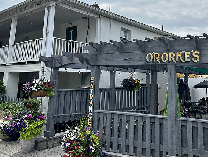 The entrance, adorned with hanging flower baskets, offers a promise of hospitality that the kitchen fully intends to keep.