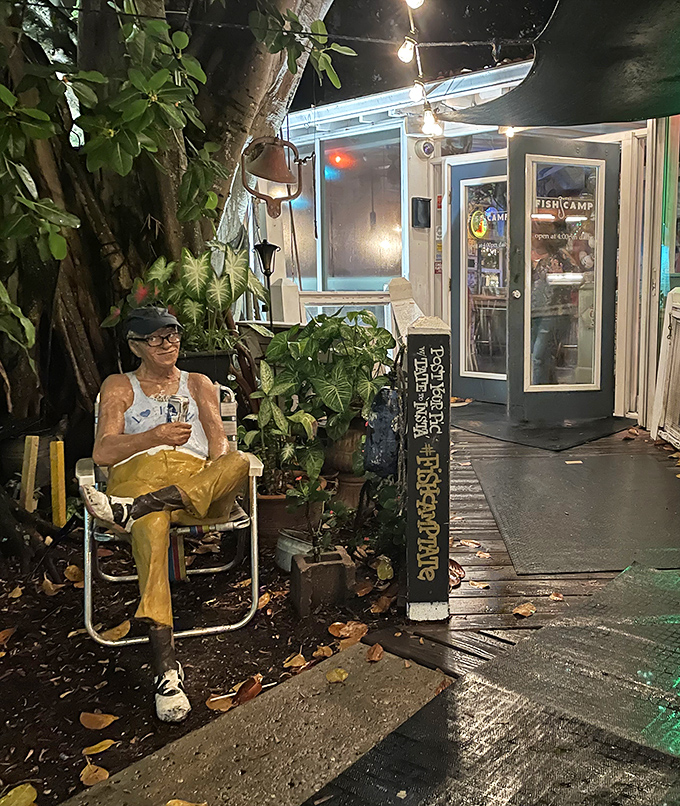 As evening falls, the entrance transforms into a magical garden where waiting for a table becomes part of the experience.