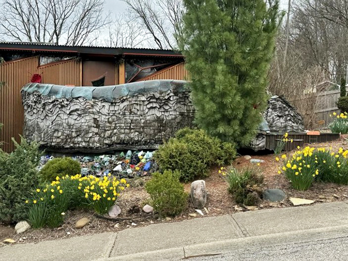 Even the daffodils seem to stand at attention, saluting this monument to creative courage and whimsy.