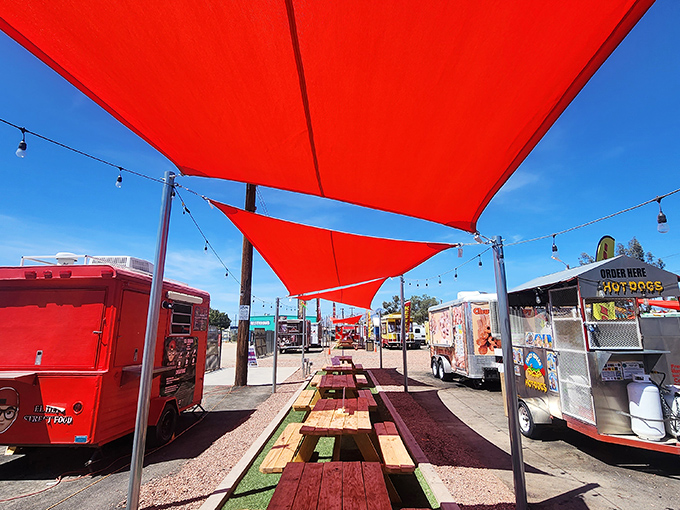 Vibrant red canopies create an oasis for hungry shoppers. These picnic tables have witnessed countless deals celebrated over delicious street food.