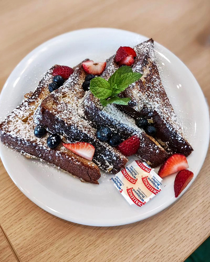 French toast that's dressed for success with berries, powdered sugar, and a mint leaf hat. Breakfast or dessert? The line deliciously blurs.