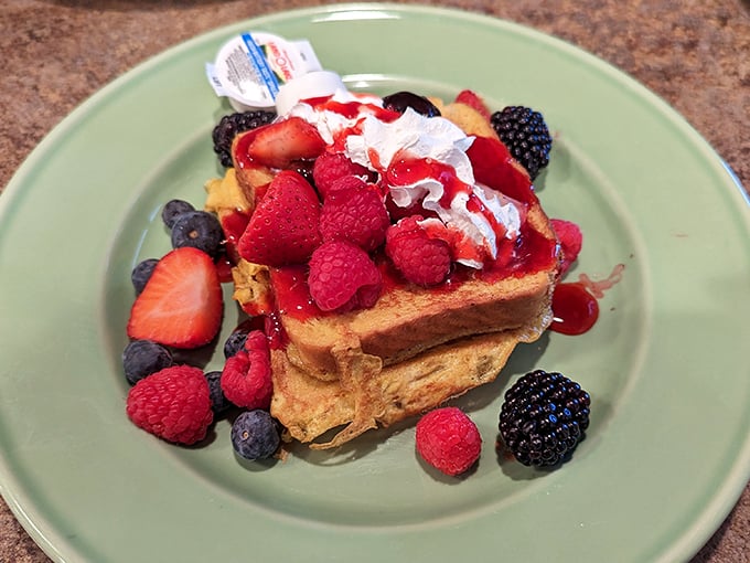 French toast that's dressed for success with berries, whipped cream, and enough visual appeal to make your phone eat first.