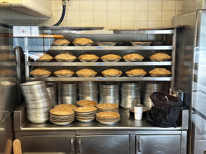 Fresh pies cooling on racks—visual proof that "homemade" isn't just marketing speak at The Apple Pan. These beauties are the real deal.