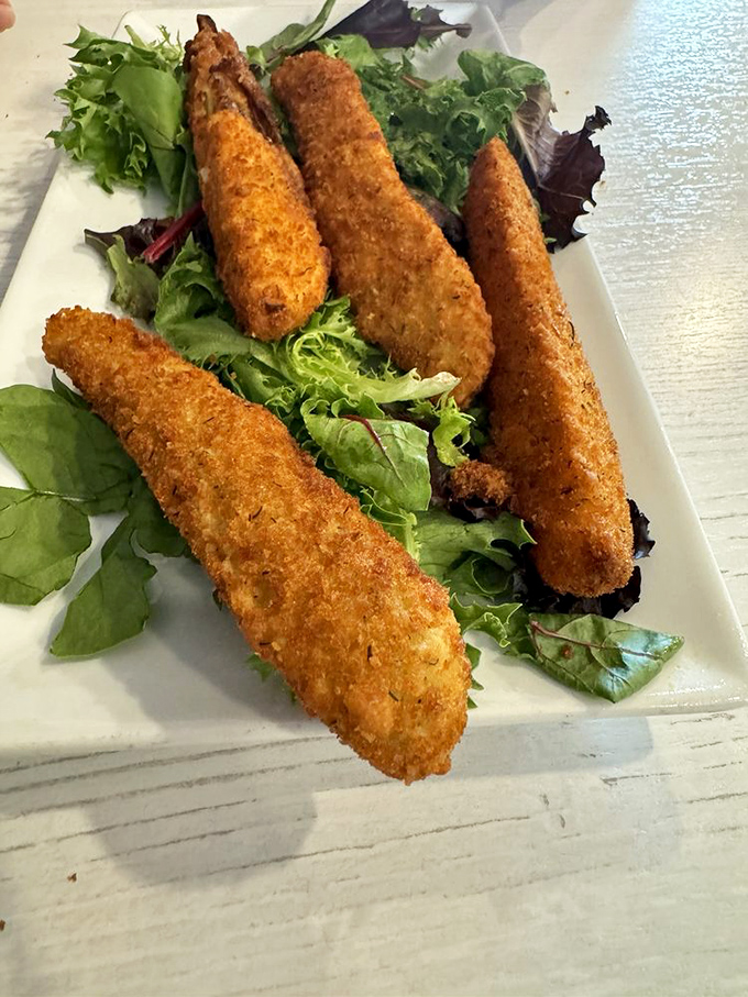 Fried pickles that could convert even pickle skeptics. Golden-crusted spears with a tangy center, proving that sometimes the best things come in unexpected packages.