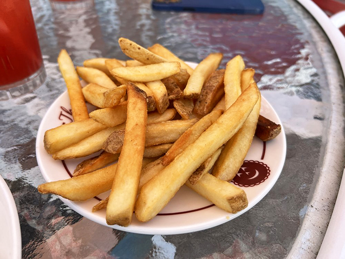 French fries done right &ndash; golden, crispy, and served on plates with smiling cherries. Even the potatoes here know they're in cherry country.