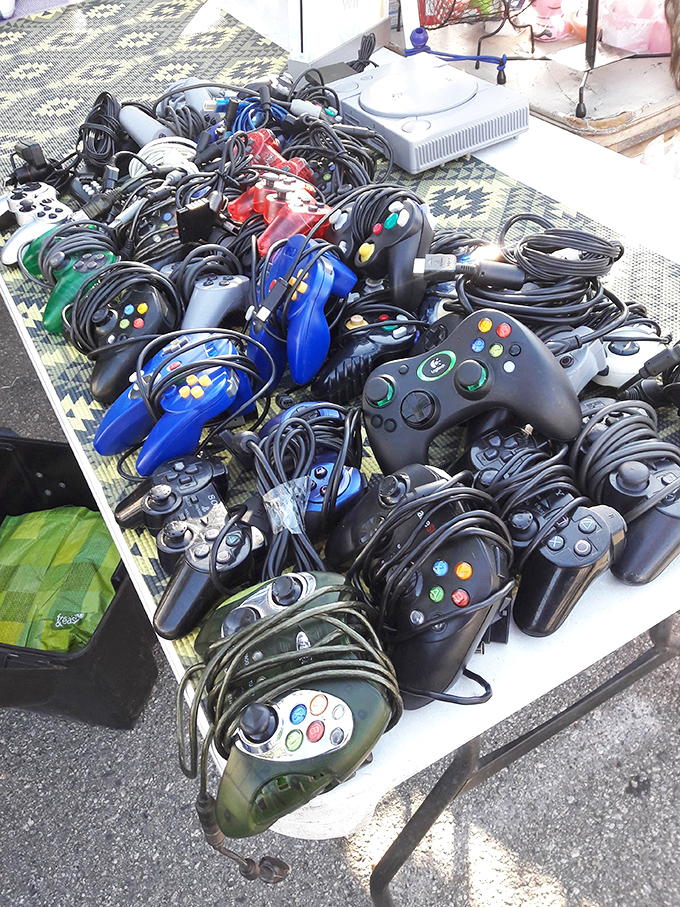 Gaming nostalgia tangles across the table&mdash;a nest of controllers from bygone console eras waiting to reconnect players with their digital youth.