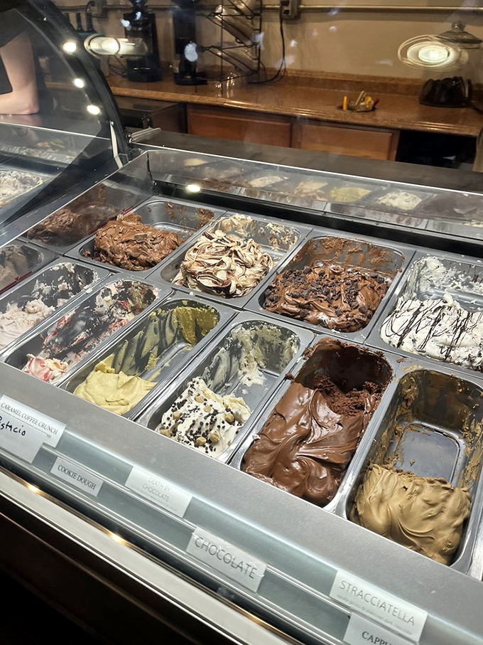 A rainbow of frozen Italian perfection. Each gelato flavor beckons with creamy promises that make choosing just one nearly impossible.