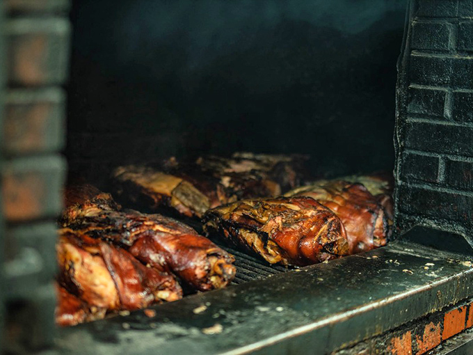 Where the magic happens—meat transforming into barbecue masterpieces in the smoky embrace of this well-seasoned pit.