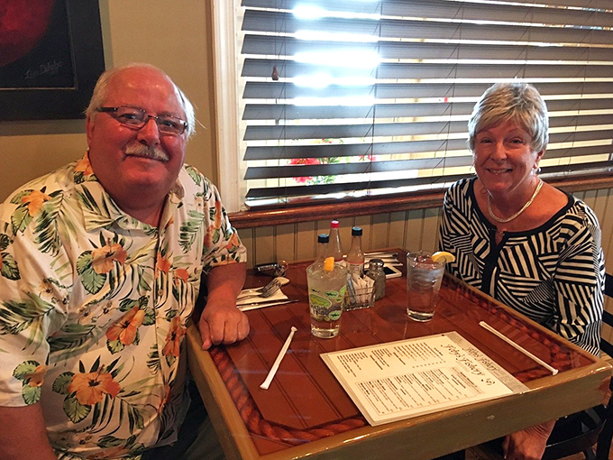 Happy diners toasting to good company and great seafood&mdash;the universal language of satisfaction translated through raised glasses.