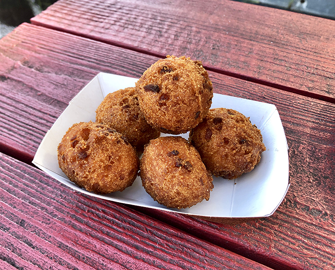 Hush puppies that speak volumes about Southern cooking traditions. Golden, crispy orbs of cornmeal perfection waiting to be devoured.