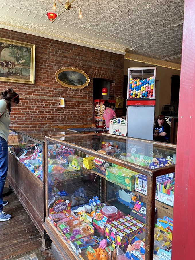 Exposed brick walls and ornate tin ceilings frame the candy displays, architecture as timeless as the treats themselves.