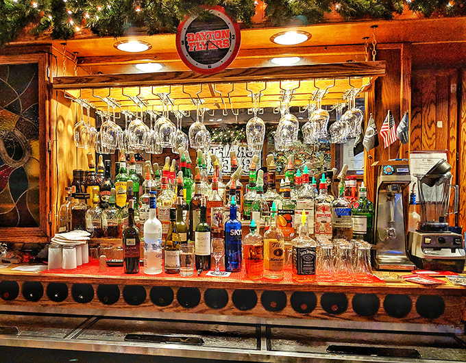 The well-stocked bar promises liquid comfort to complement your smoky feast. Those hanging glasses await their moment to shine.