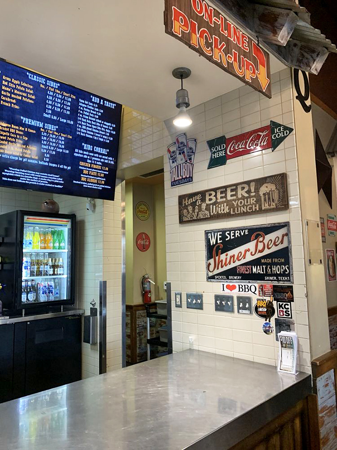 Vintage signs and barbecue wisdom adorn walls that have witnessed countless moments of smoky satisfaction.