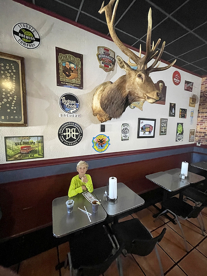 The décor says "hunting lodge meets burger paradise." That mounted elk watches over diners like a benevolent spirit animal of meat appreciation.
