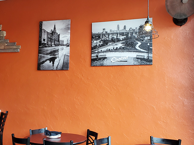 Cleveland pride on vibrant orange walls&mdash;black and white cityscapes remind you that great food and hometown love go hand in hand.