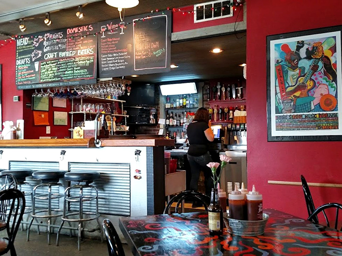 Red walls and music posters create an atmosphere where every meal feels like a celebration of American comfort food culture.
