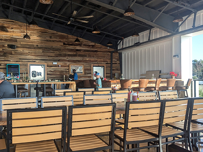 The dining room's rustic wood walls and industrial ceiling create an atmosphere that's both casual and inviting.