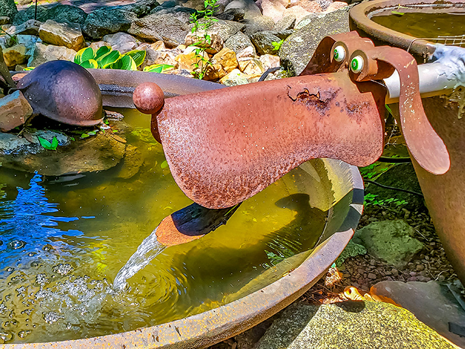 This metal dog happily splashes in its pond, adding a delightful water feature to the already impressive outdoor sculpture garden.