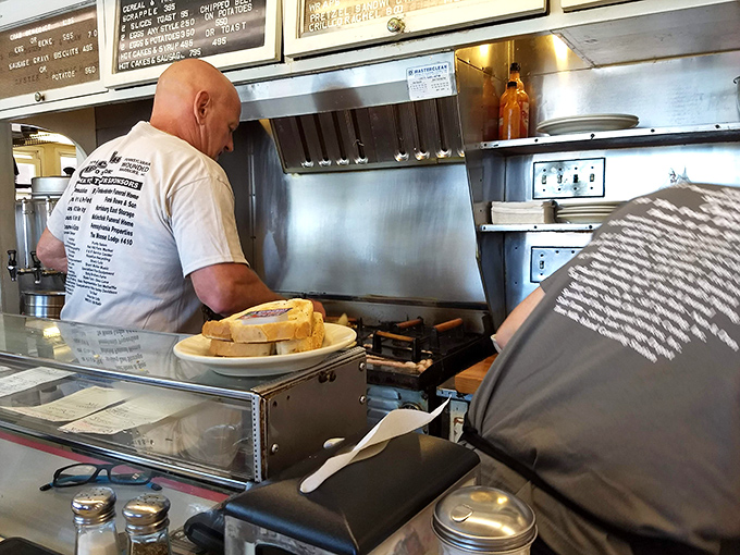 Where the magic happens: A short-order cook orchestrating the breakfast symphony with the precision of a seasoned conductor.