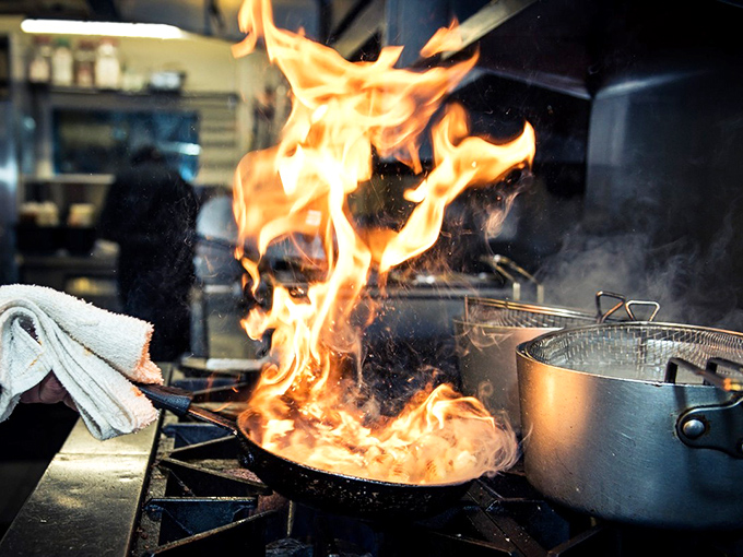 Fire-kissed perfection in progress. In the kitchen, flames leap and dance&mdash;nature's way of telling you this meal is going to be memorable.