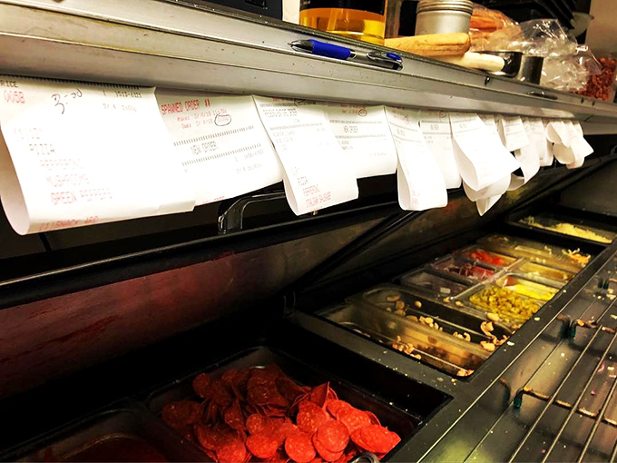 The pizza assembly line&mdash;where toppings wait like actors in the wings before their starring role on your perfect pie.