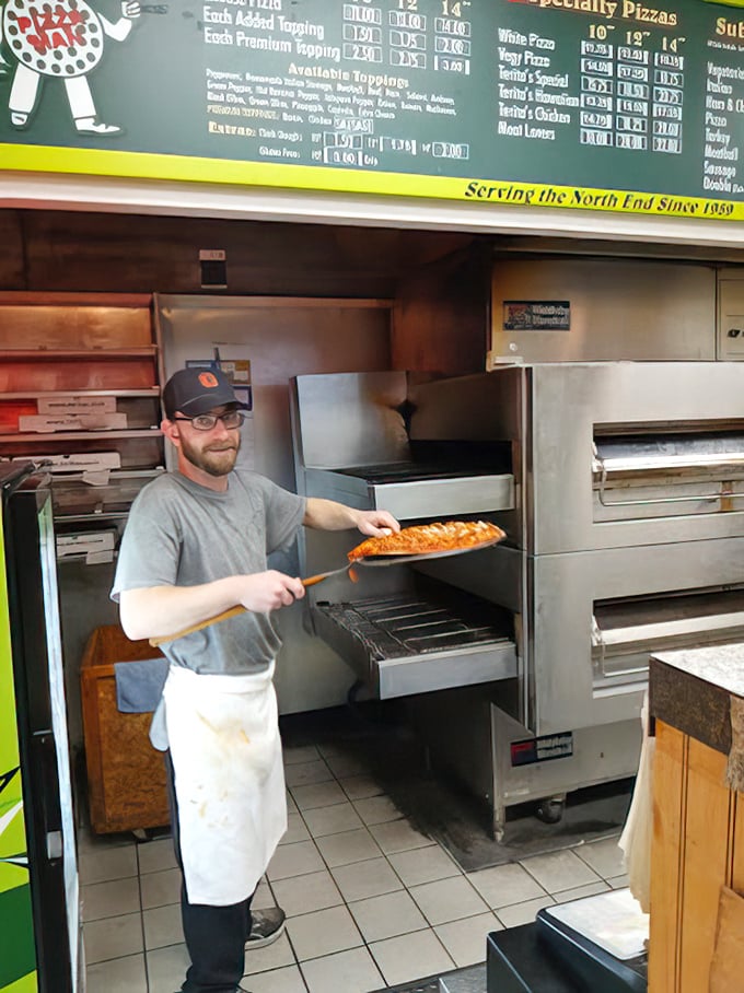 The pizza paddle in action &ndash; that moment of anticipation when your pie is about to meet its destiny in the oven.