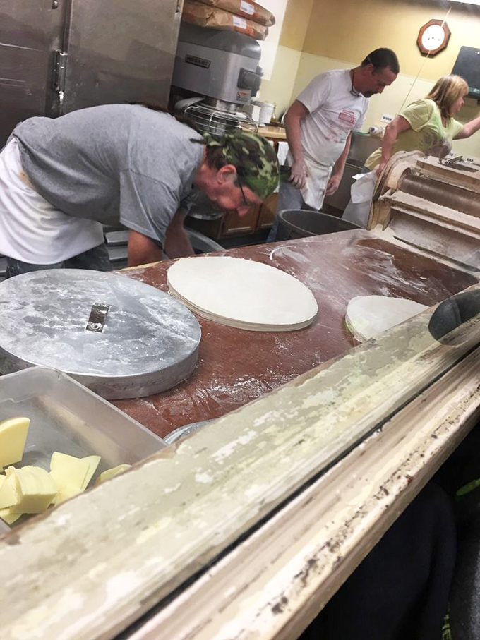 Dough-making is serious business here. These hands have created more happiness than most therapists, one perfect crust at a time.