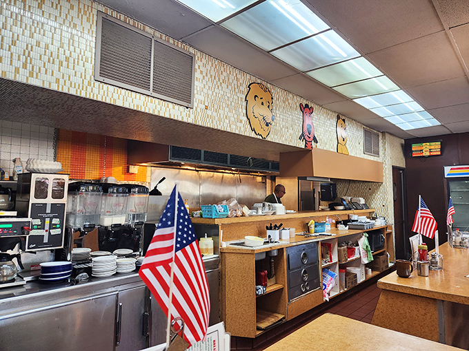 The open kitchen where breakfast magic happens, complete with patriotic flair and circus-themed wall decorations watching over the griddle.