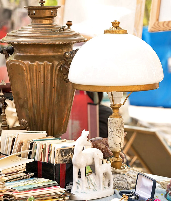 Vintage lamps and brass treasures huddle together, as if sharing secrets about the homes they once illuminated.