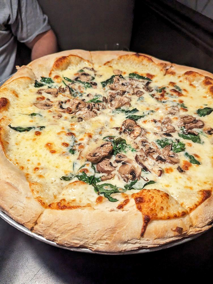 This mushroom and spinach pizza isn't just food&mdash;it's a bubbling canvas of melted cheese art that belongs in both galleries and stomachs.