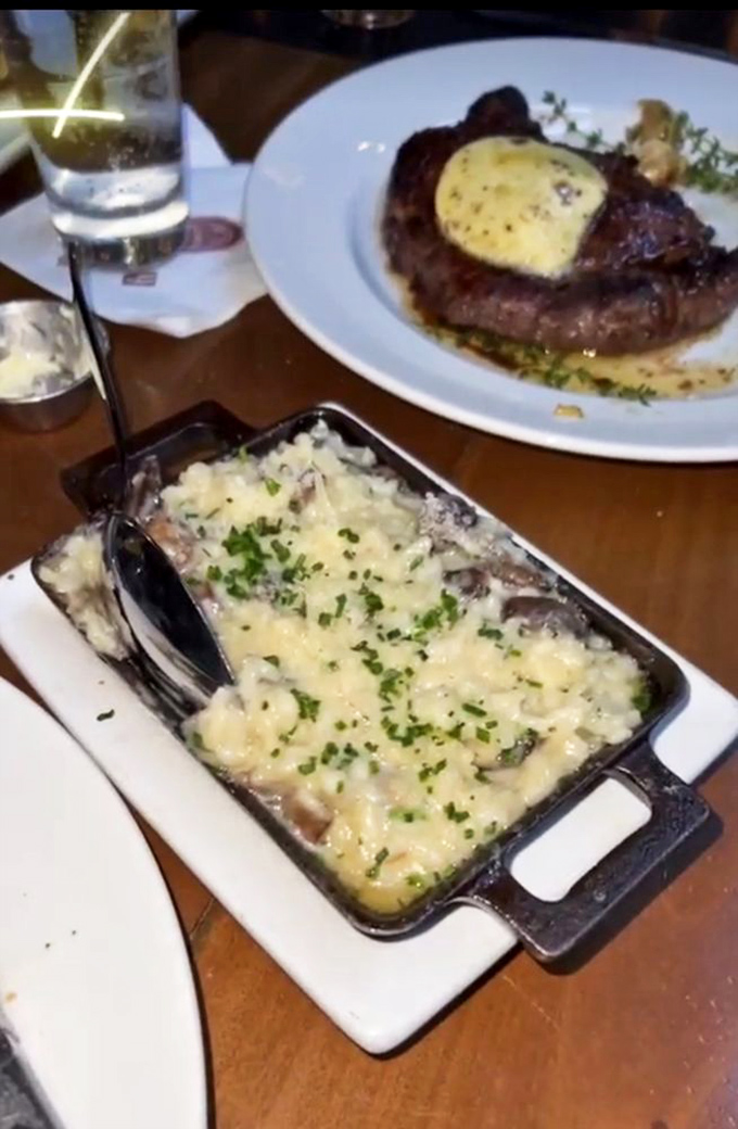 A steak topped with compound butter melting into creamy mushroom risotto. Some food photographers use tricks&mdash;this dish needs none.