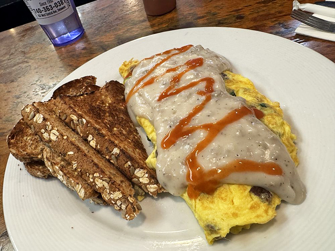 An omelet draped in country gravy with hot sauce racing stripes&mdash;breakfast engineering at its finest.