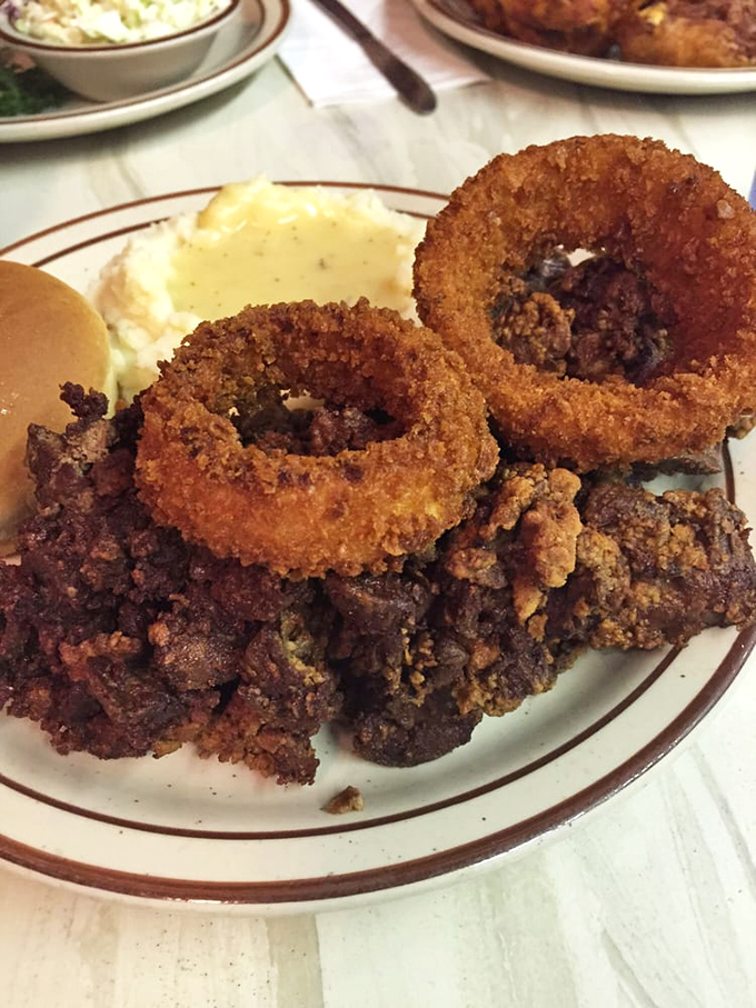 Onion rings that deserve their own spotlight, not just a supporting role. That golden-brown coating shatters with satisfying precision.