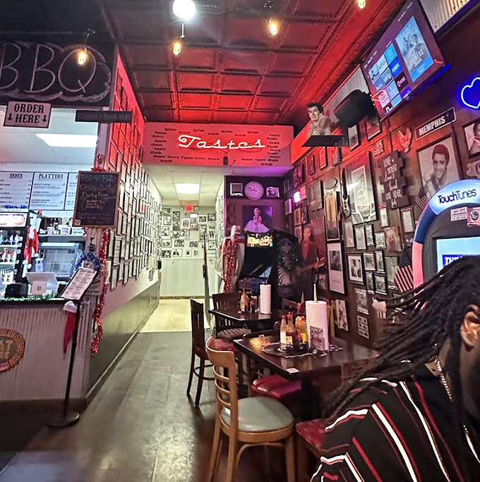 Red lighting bathes the dining area in a warm glow that says, "Stay awhile, order another round of ribs, tomorrow's problems can wait."