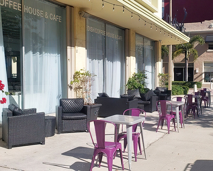 The outdoor seating area offers a splash of purple against white walls. Florida's sunshine and Sweden's design sensibility create the perfect outdoor fika spot.