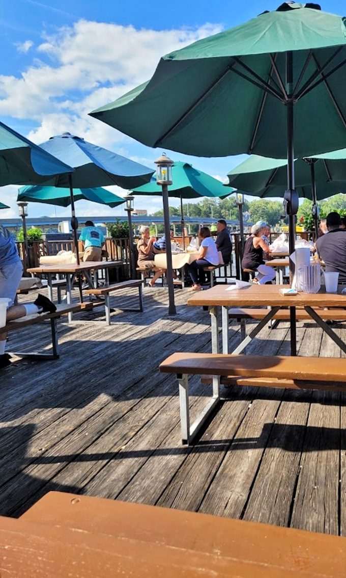 Dining under those turquoise umbrellas with water views feels like you've stumbled into someone else's vacation photos—except it's actually your life.