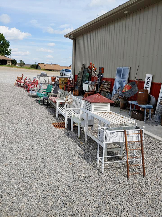 Porch furniture patiently waiting for its next home. These white-painted treasures have witnessed countless summer evenings and lemonade conversations.