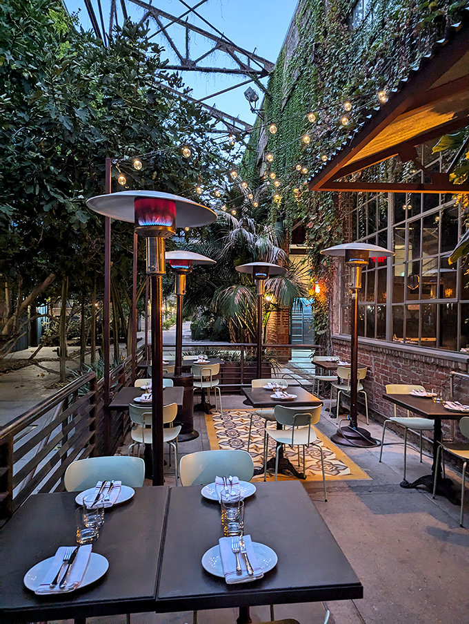 The outdoor patio feels like stumbling into a secret garden party where string lights and heat lamps create year-round dining perfection.