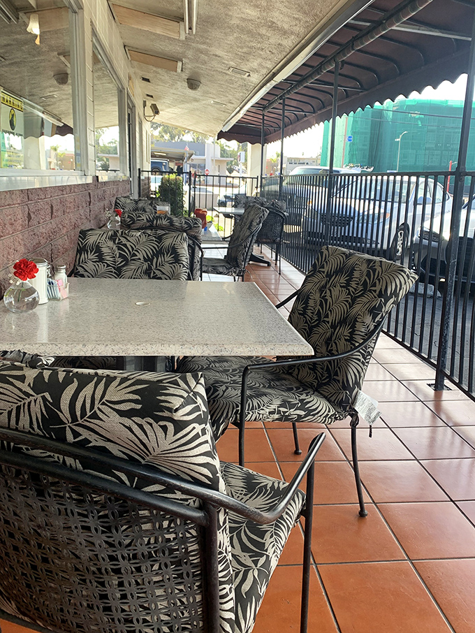 Outdoor seating with tropical-patterned chairs &ndash; California sunshine included at no extra charge with every breakfast order.