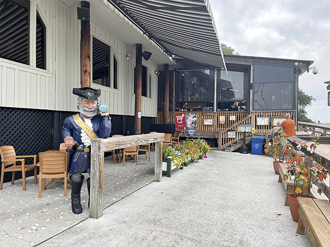 Outdoor seating with another pirate standing guard. He's holding a drink, setting the perfect example for proper Murrells Inlet behavior.