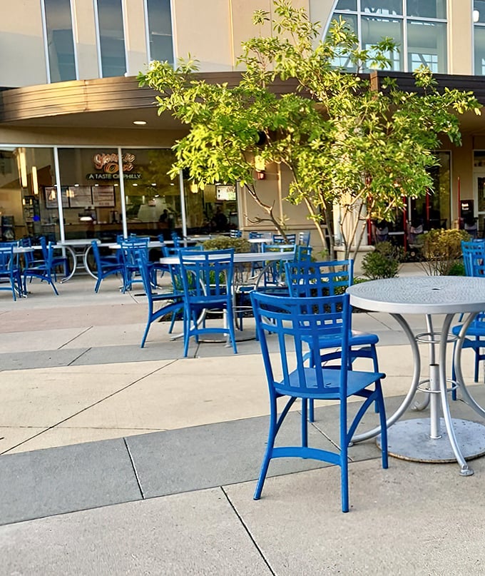 Cheerful blue outdoor seating invites shoppers to enjoy a moment of fresh air and people-watching between wallet-friendly purchasing expeditions.