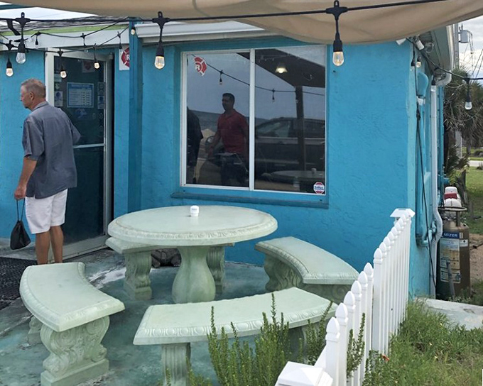 Al fresco dining with coastal charm. This stone table setup offers the perfect perch to enjoy sea breezes with your seafood&mdash;nature's perfect pairing.