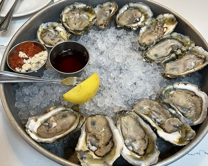 A dozen glistening oysters on ice form a perfect circle of briny bliss&mdash;nature's perfect appetizer waiting for a squeeze of lemon.