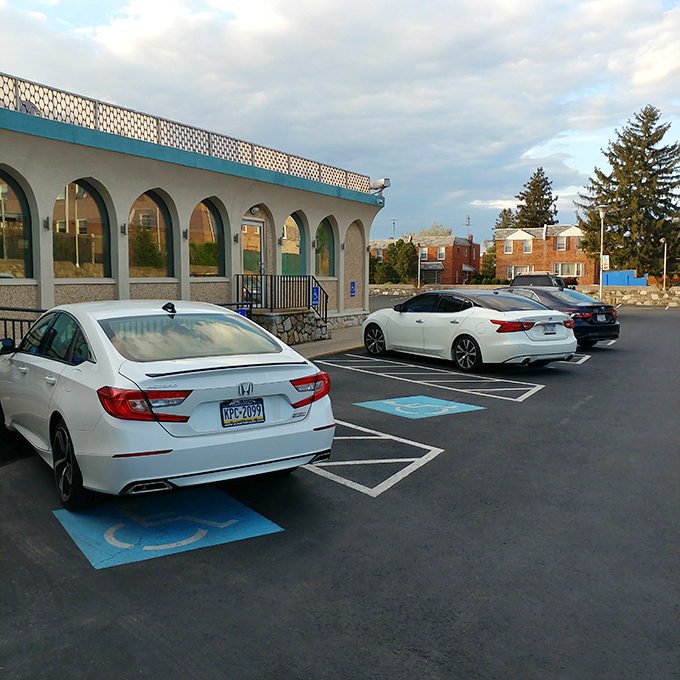 Even the parking lot maintains that distinctive mid-century charm, with the arched windows of the diner creating a welcoming silhouette against the sky.