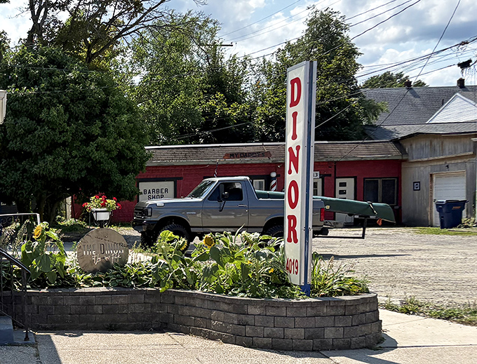 The vertical "DINOR" sign (Erie's unique spelling) stands tall among neighborhood landmarks, a sentry guarding decades of breakfast traditions and community connections.
