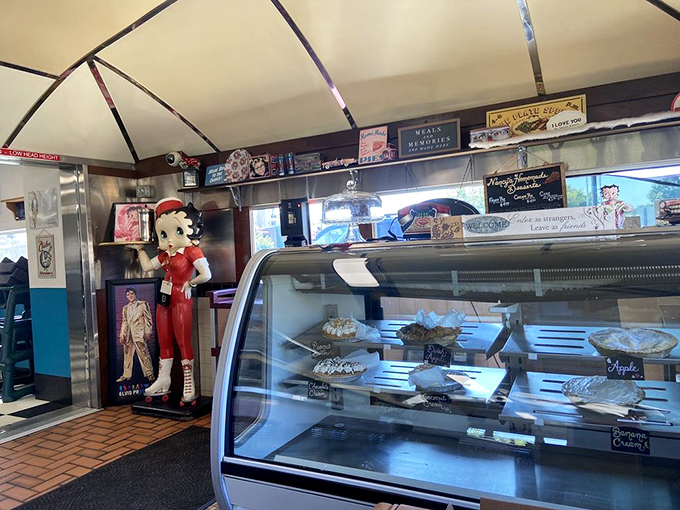 Pie display that stops conversations mid-sentence &ndash; glass case treasures that make you reconsider saving room for dessert before you've even ordered.