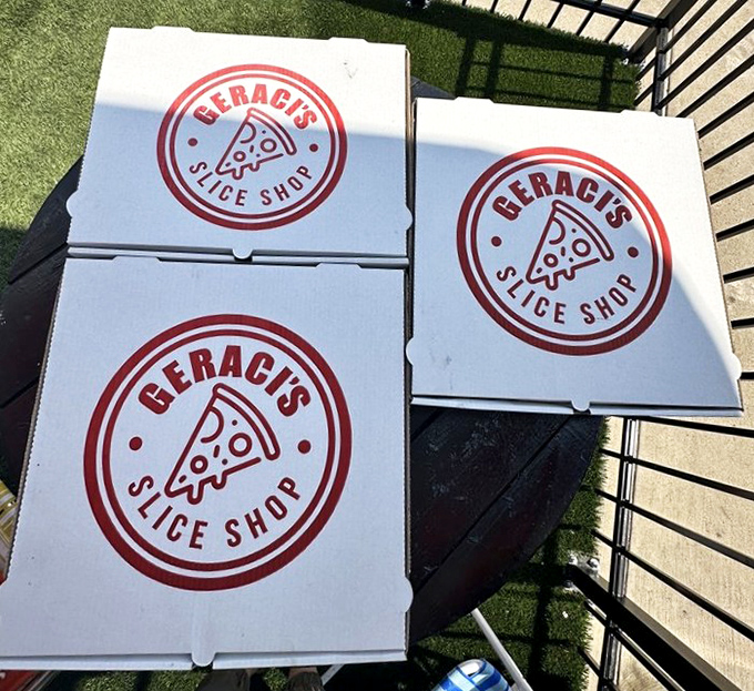 Pizza boxes stacked like presents waiting to be opened. The best things in life come in cardboard squares with circular treasures inside.